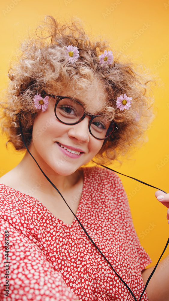 Attractive girl wearing nerdy spectacles smiling at the camera. Girl in a joyful mood and ...