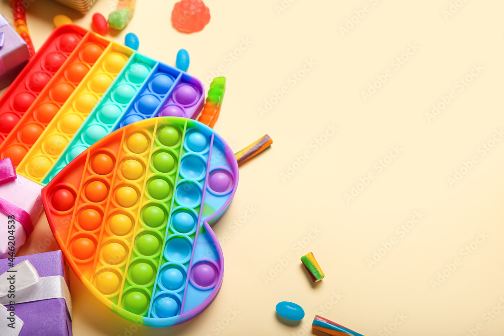 Pop it fidget toys and gifts on color background Stock Photo | Adobe Stock