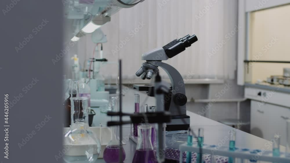 Slowmo tracking shot of interior of chemistry lab Microscope, test ...