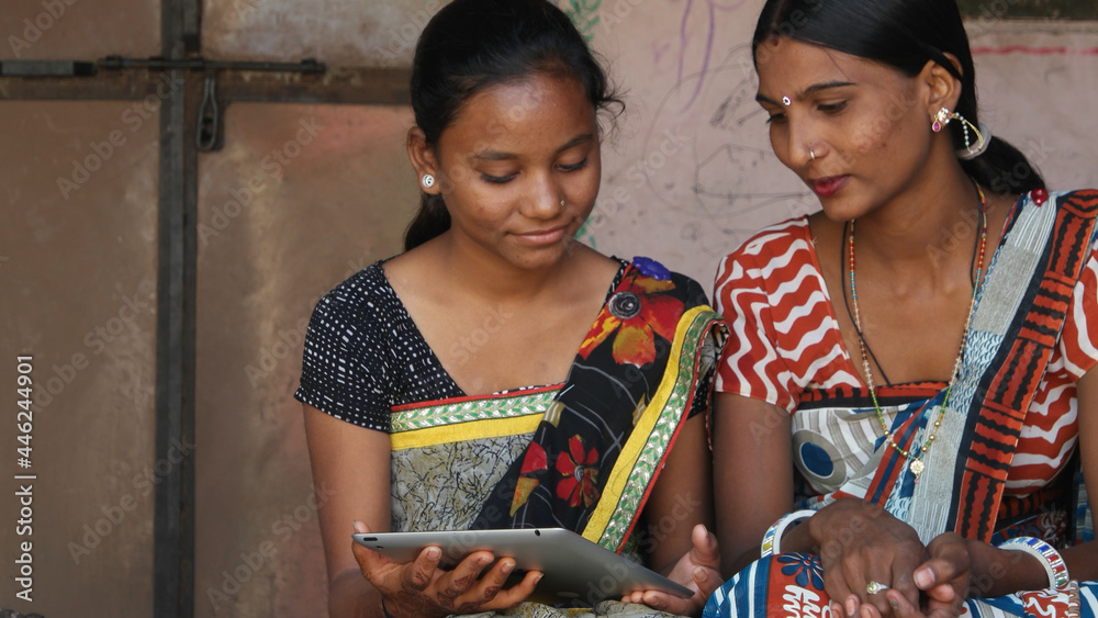 Happy Indian girls in traditional clothes sitting outdoor Stock Photo ...