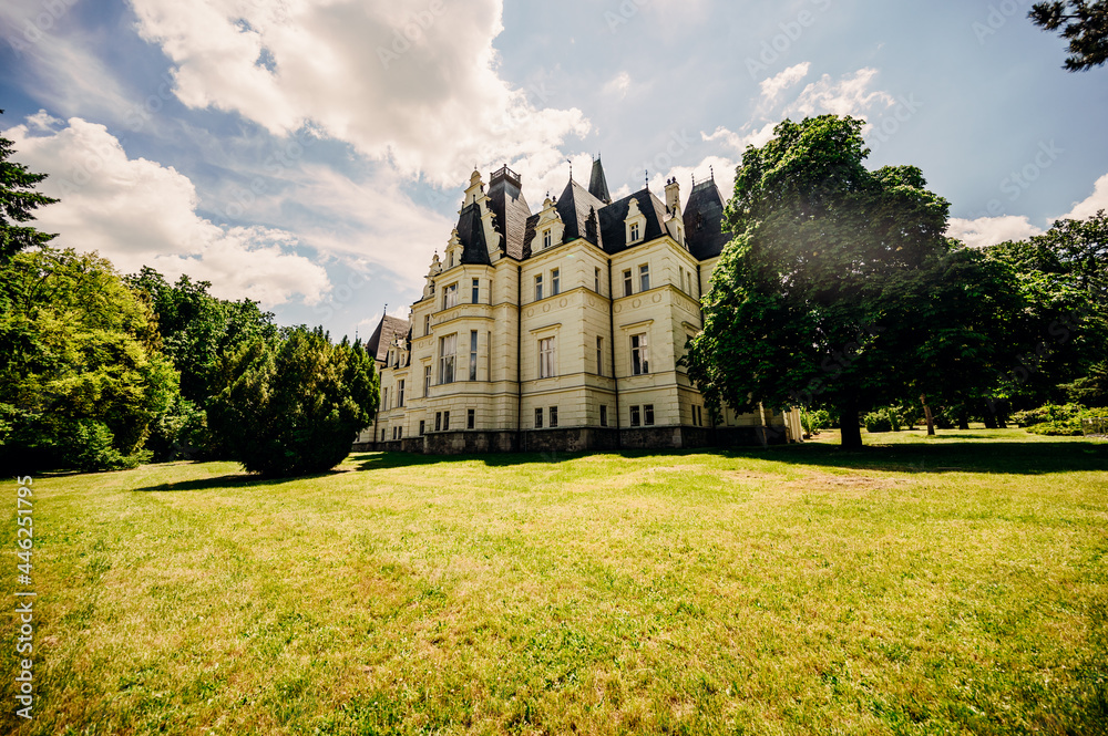 Budmerice Castle from 19th century in nature landscape. Tree in forest ...