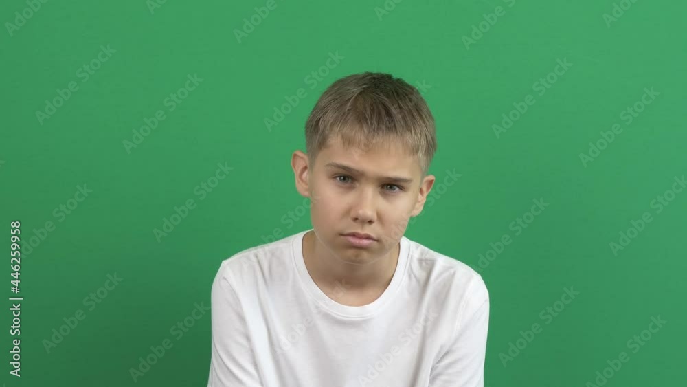 Upset disappointed depressed teenage boy sitting lowered his head ...