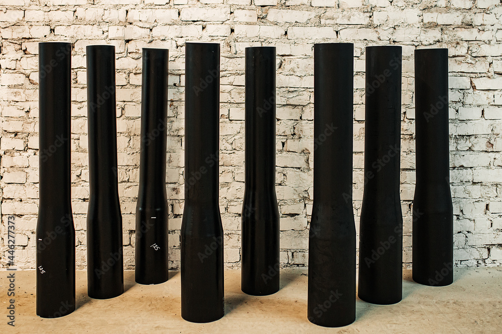 black cylindrical plastic pipes of different diameters are in stock ...