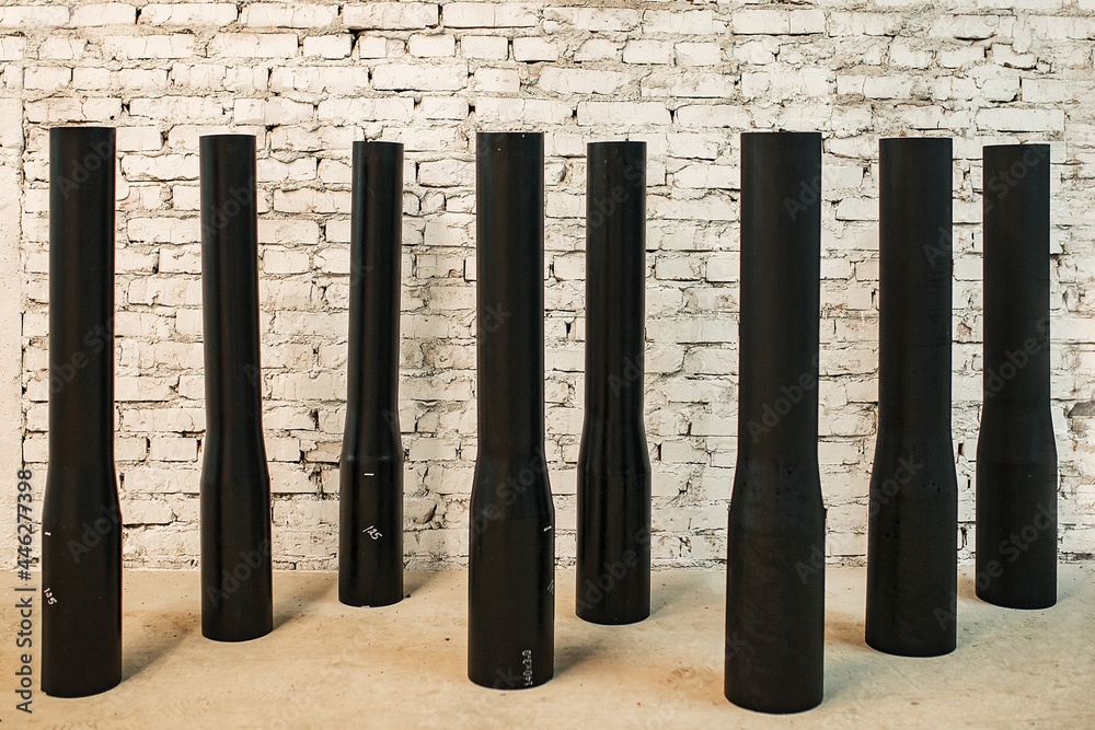black cylindrical plastic pipes of different diameters are in stock ...