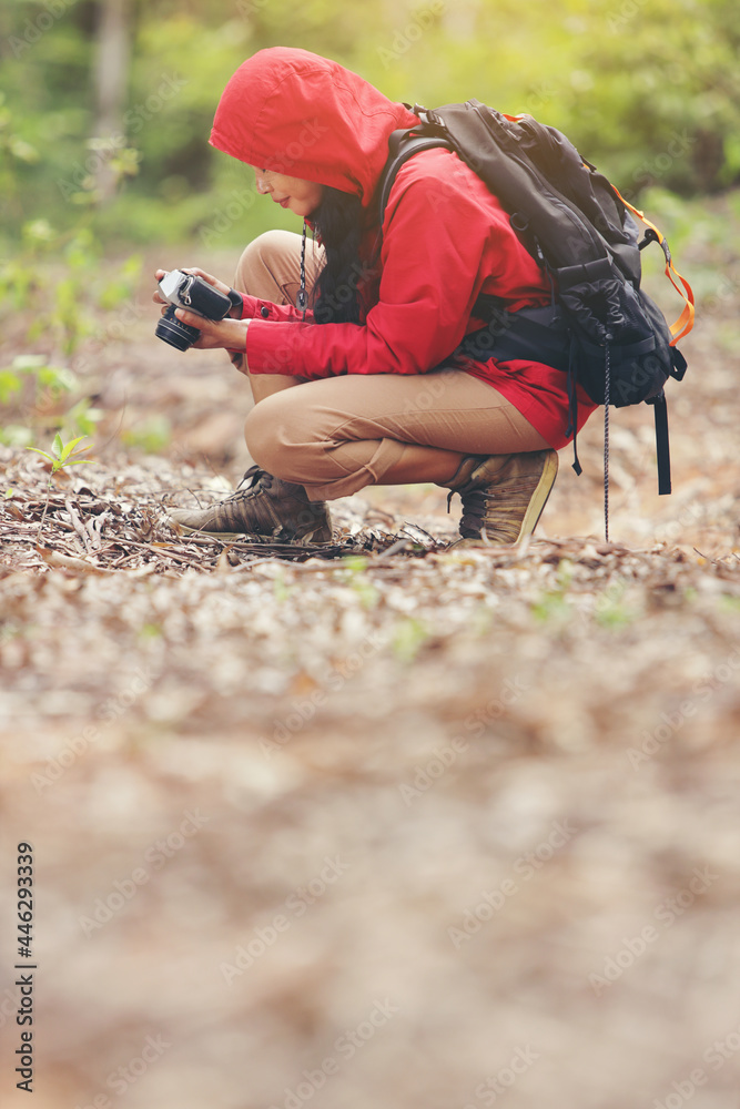 Tourist girl in red dress She went on a trip to photograph various ...