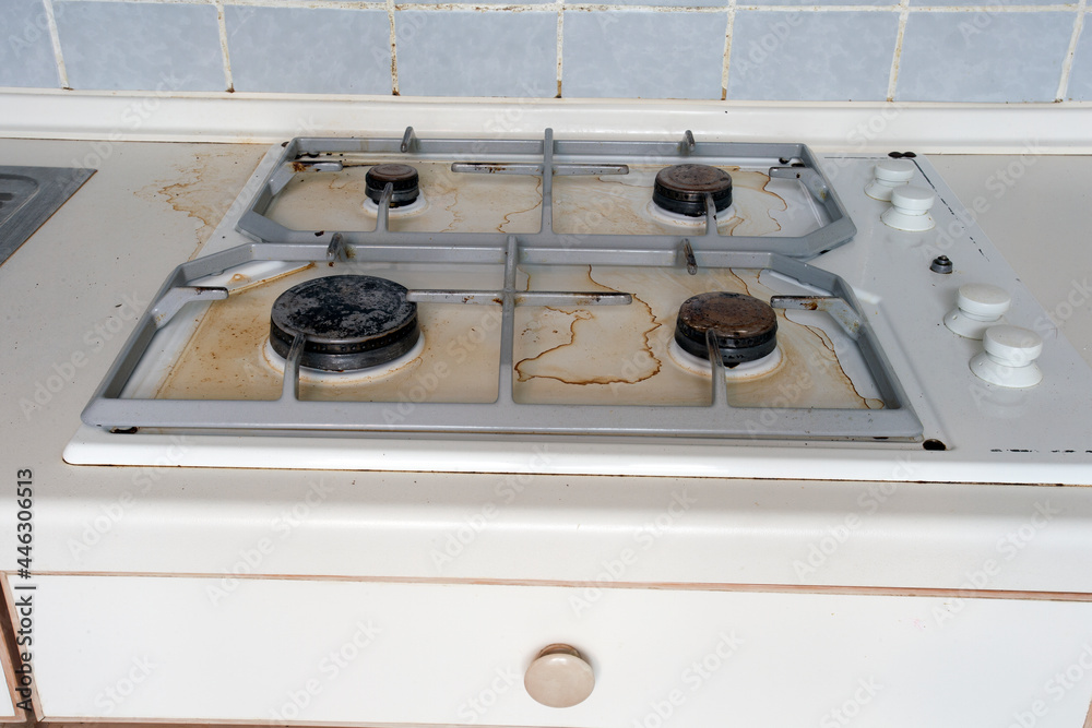 Dirty gas stove cooking oil stains on gas stove in kitchen.An Unclean ...