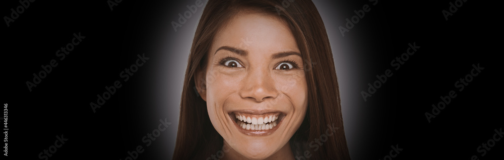 Scary face expression of crazy Asian girl with evil smile on black ...