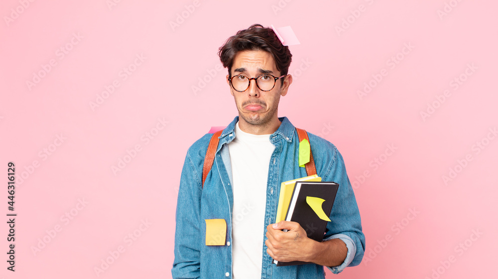 young hispanic man feeling sad and whiney with an unhappy look and ...