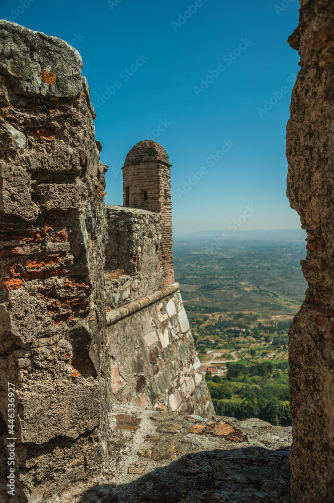 Stone wall and watchtower over cliff with hilly landscape seen by ...