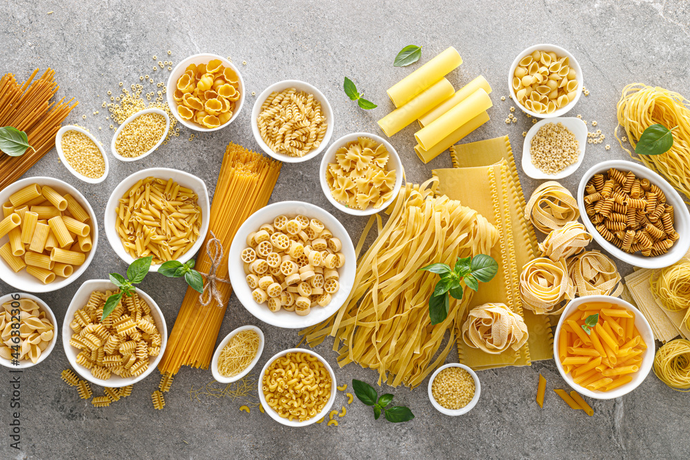 Pasta. Various kinds of uncooked pasta and noodles over stone ...