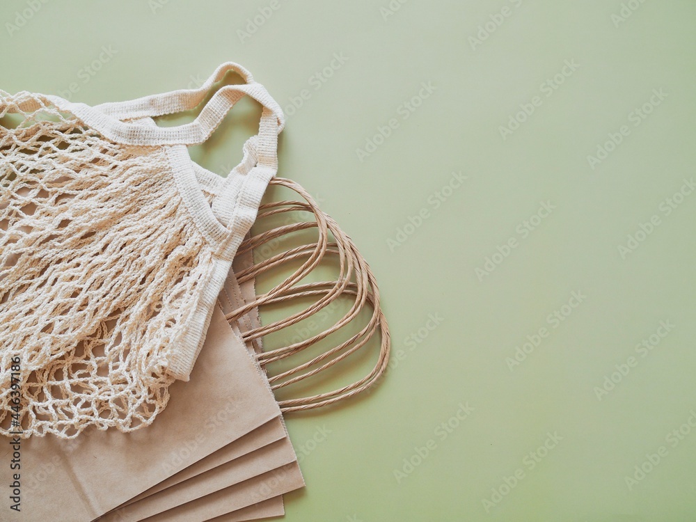 Biodegradable paper bags and reusable mesh Cotton shopper on neutral ...