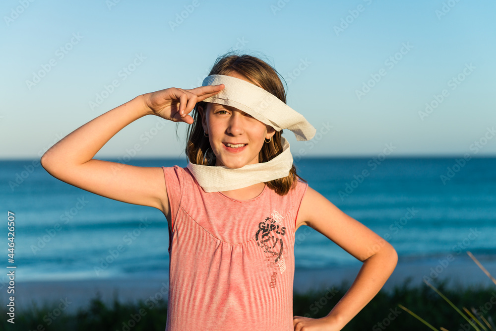 tween girl being silly, making an eye patch with toilet paper, and ...