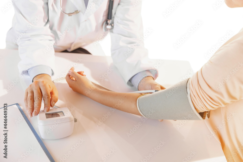 Close-up hands of doctor, therapeutic or medical advisor measuring ...