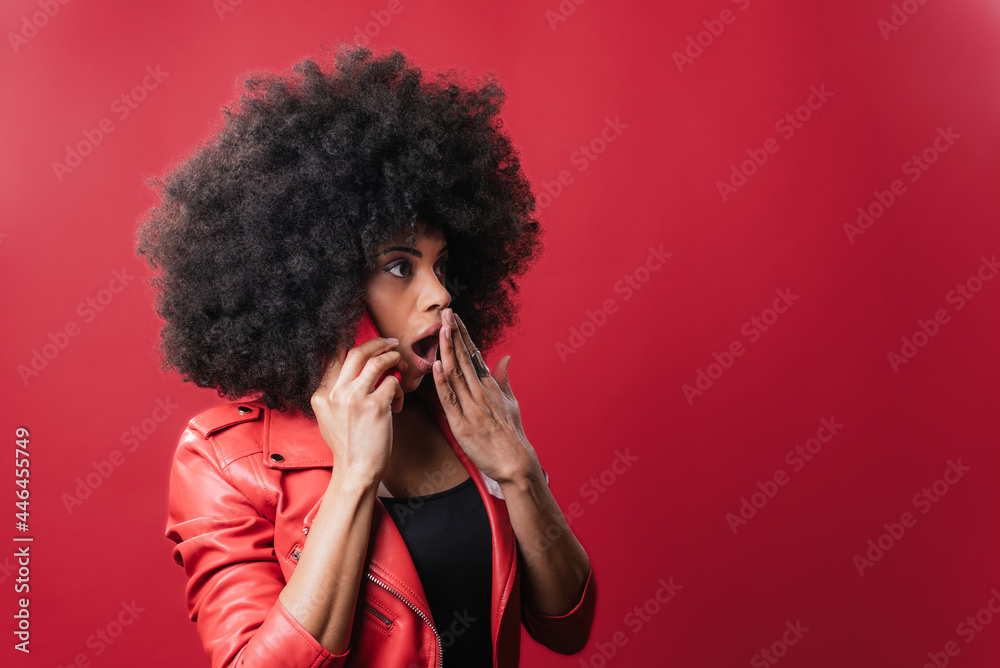 Shocked black woman talking on smartphone and gossiping Stock Photo ...