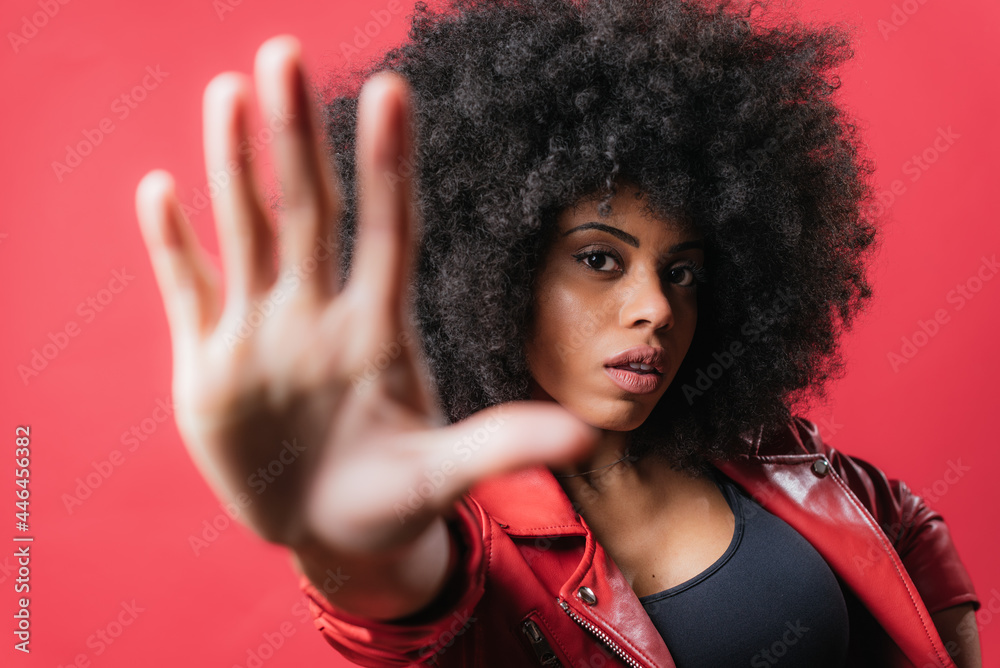 Scared black woman showing stop sign on red background Stock Photo ...