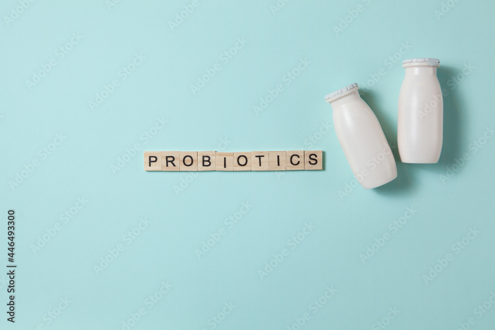Bottles with probiotics and prebiotics dairy drink on light blue ...