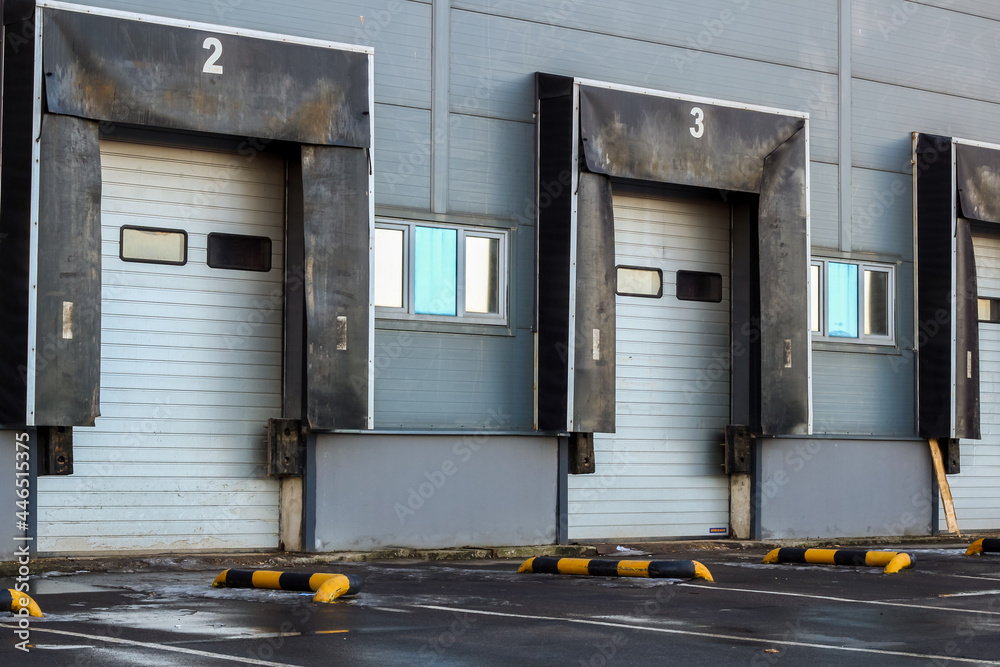 Row of loading docks with shutter doors at a warehouse. Warehouse ...