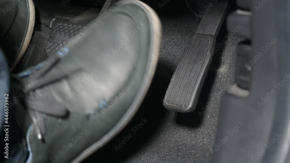 Accelerator and break pedal in a car. Close up the foot pressing foot ...
