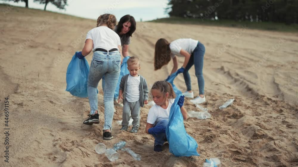 Family cleaning up plastic trash. People are eliminating environmental ...