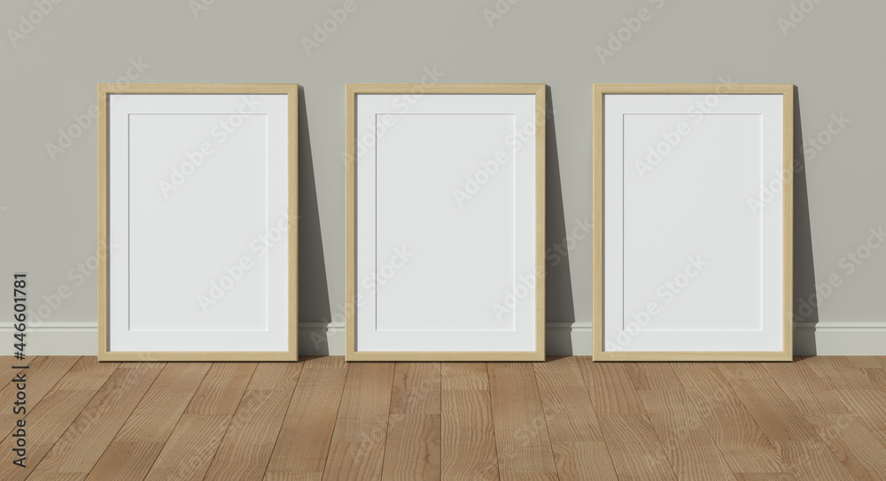 Wooden frames on wooden floor with a painted wall. 3D render vertical wooden frame mock up. Oak ...