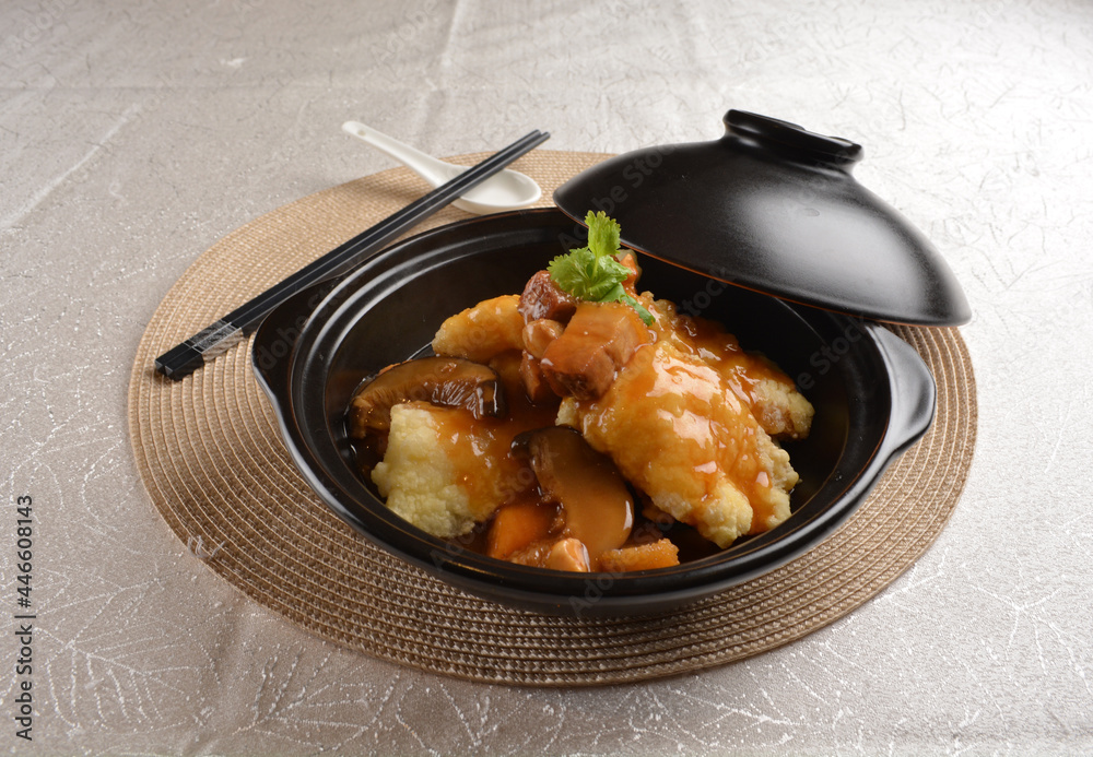 deep fried grouper fish fillet seafood in black hot clay pot with ...
