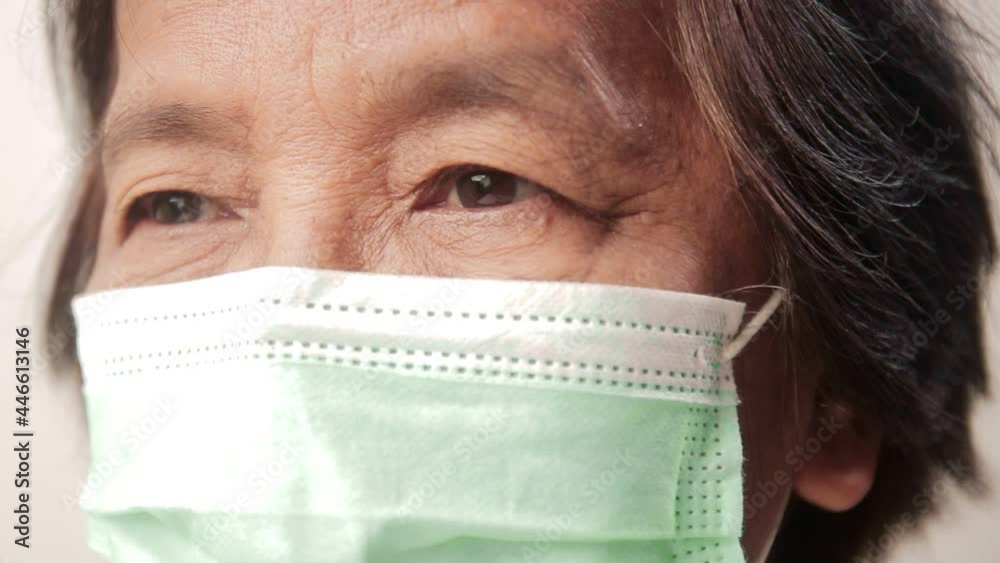 Close-up view of Asian elderly woman's face Wear a mask to prevent ...