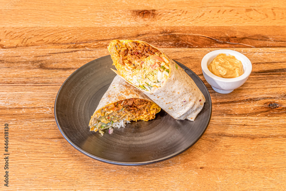 Mexican burrito of tacos al pastor with dip sauce wrapped in wheat ...