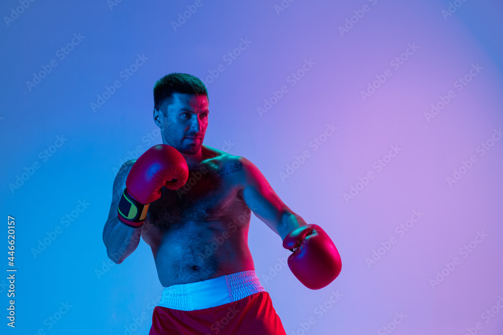 One man, professional boxer in sportwear boxing on studio background in ...