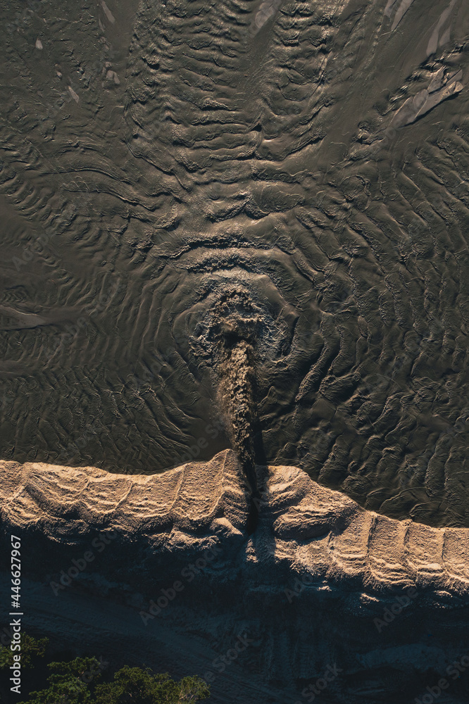 Flow of dirty water with sand during the extraction of sand. Waves ...