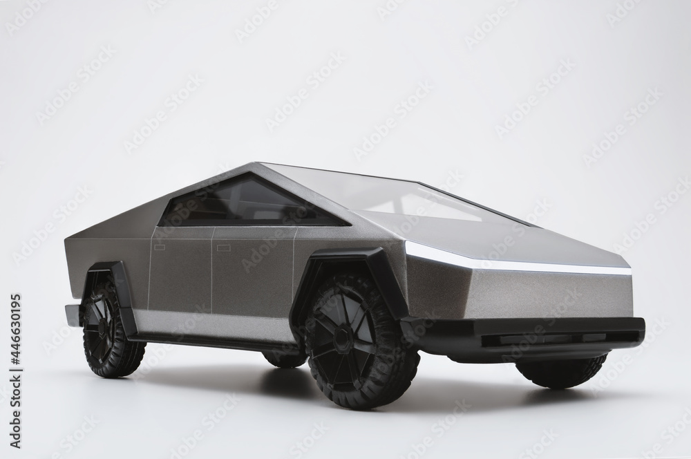 Tesla brand cybertruck pickup car on a white background with headlights ...