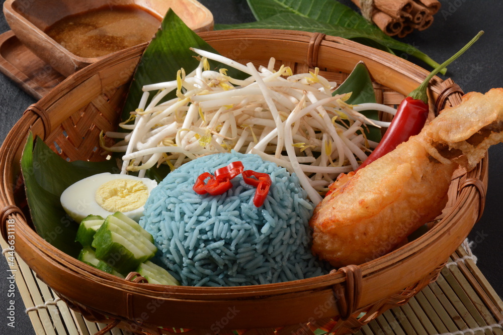 Nasi kerabu or nasi ulam, popular Malay rice dish. Blue color of rice ...