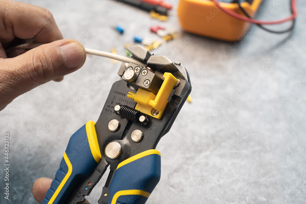 Wire strippers or cable strippers tool . Electrician holding cable ...