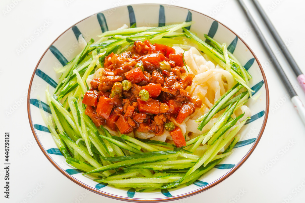 Roman noodle with pork sauce and cucumber close up. Chinese food. Za ...