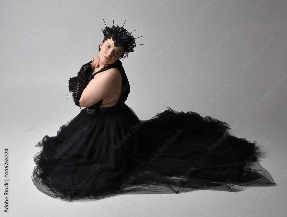 Full length portrait of young plus sized woman with short hair, wearing ...