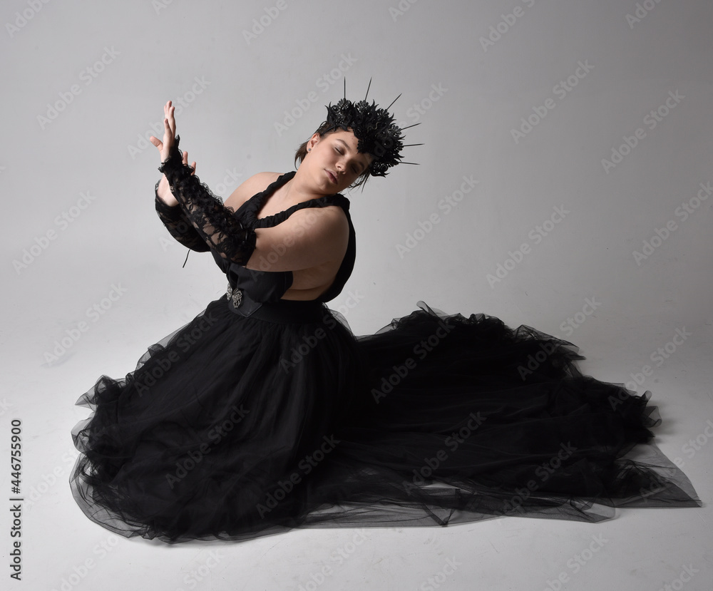 Full length portrait of young plus sized woman with short hair, wearing ...