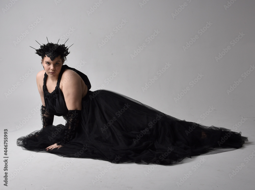 Full length portrait of young plus sized woman with short hair, wearing ...