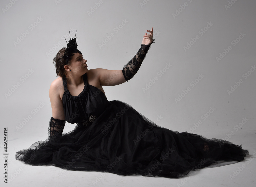 Full length portrait of young plus sized woman with short hair, wearing ...