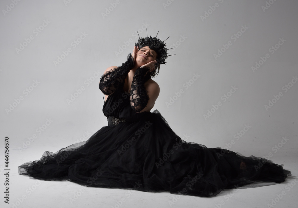 Full length portrait of young plus sized woman with short hair, wearing ...