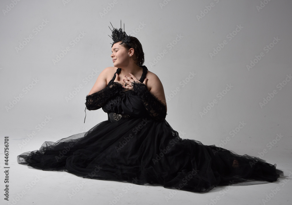 Full length portrait of young plus sized woman with short hair, wearing ...