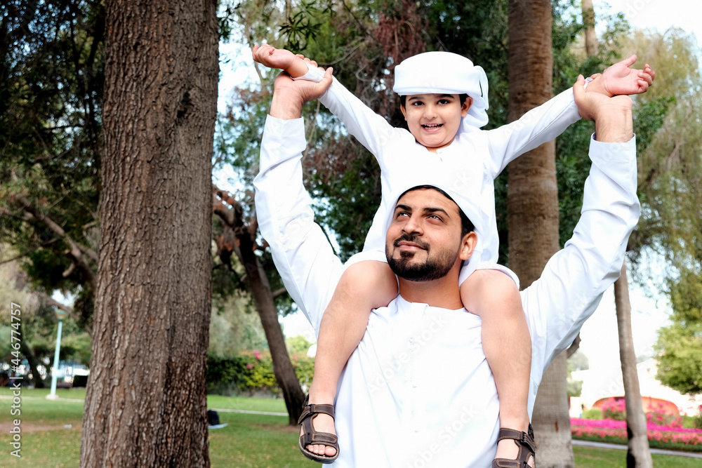 Kid plays flying super man. Side view of smiling Young Arabic boy. Arab ...