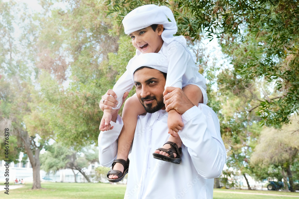 Father and son bonding spending time together. Emirati family wearing ...