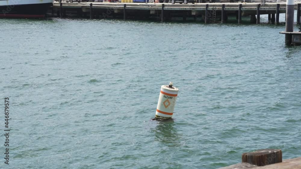 This scenic video shows a hazard buoy floating in harbor waters. Stock ...