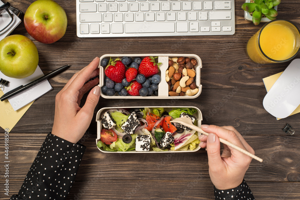 First person top view photo of hands eating healthy food salad berries ...