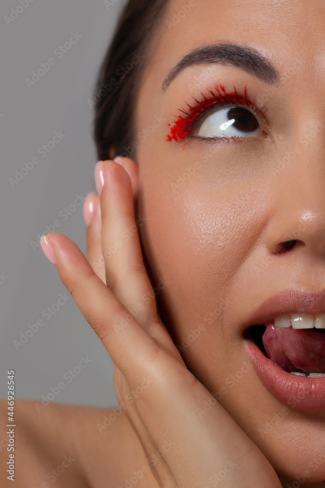 Half of a woman's face with open mouth, white teeth and protruding ...