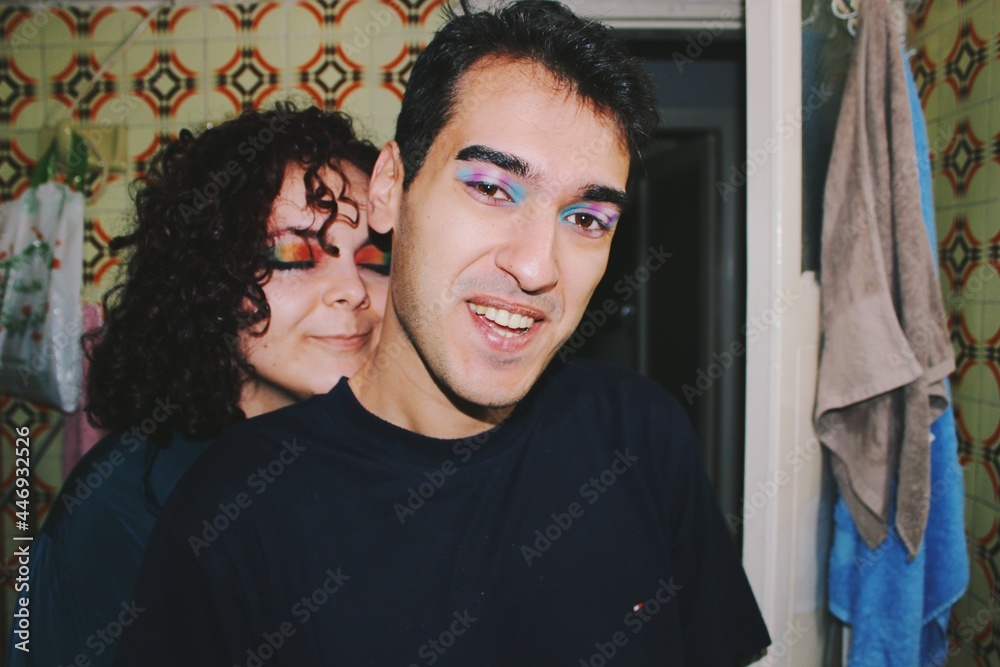 Portrait of queer friends / young couple wearing eyeshadow makeup of ...