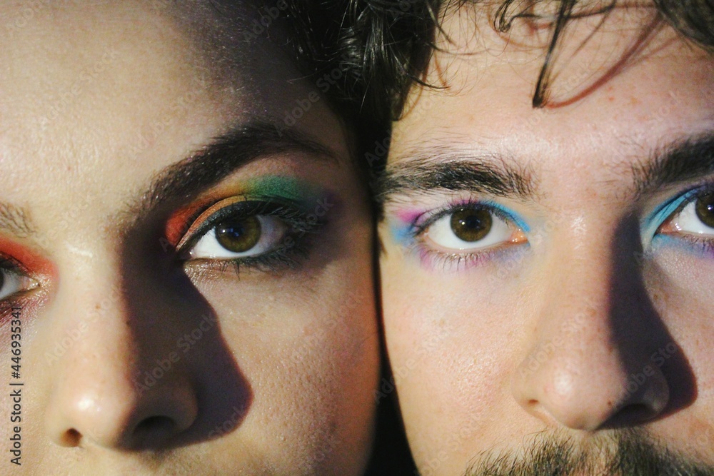portrait of closeup faces of two lgbtq queer friends faces with rainbow ...