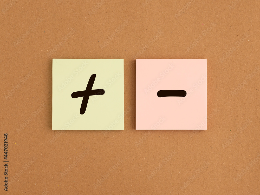 Plus and minus signs on papers. Concept of positive and negative, pros ...