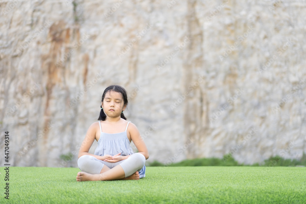 Asian child meditate zen or kid girl close eye mind meditating with ...