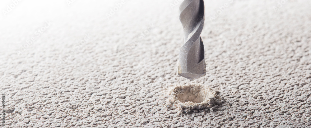 drill bit make holes in concrete wall with industrial drill. Building ...