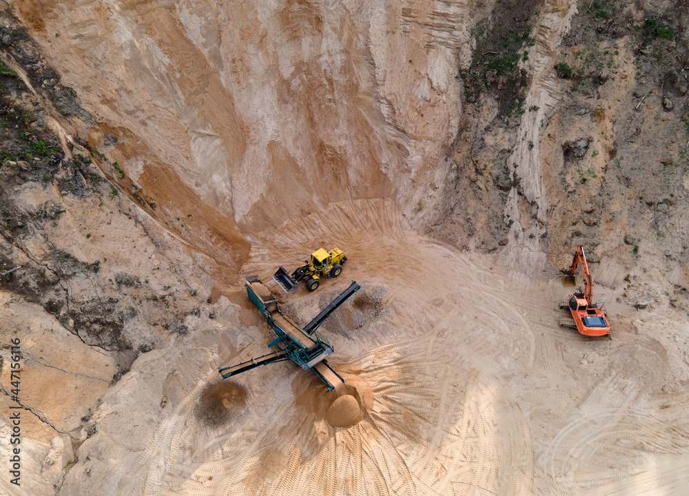 Arial view of the open pit mine. Front end loader loading gravel into ...